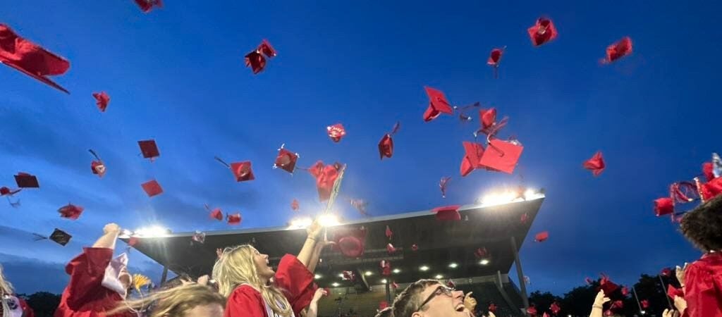 Throwing Graduation Red Caps In The Air